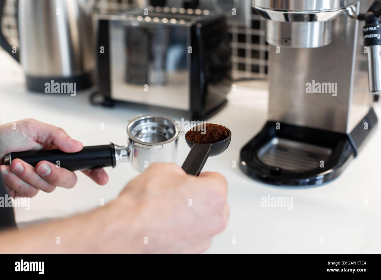 Guy prepare delicious aromatic coffee in a coffee machine. A simple way ...