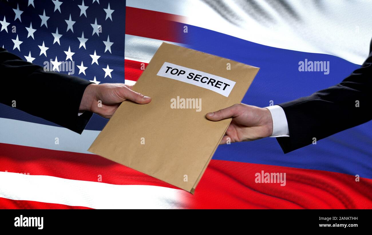 USA and Russia politicians exchanging top secret envelopes, flags ...