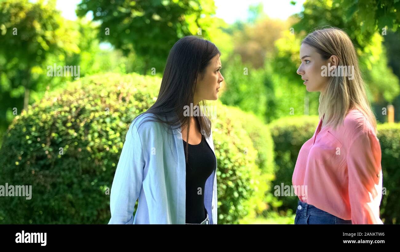 Angry young women looking each other, friendship quarrel ...