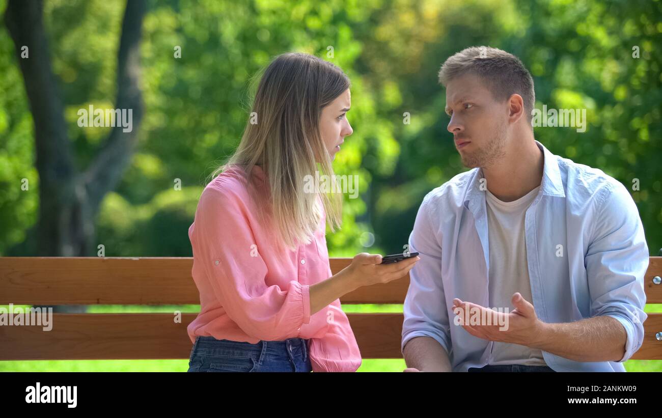Girlfriend scolding boyfriend holding phone hands, secret betrayal ...