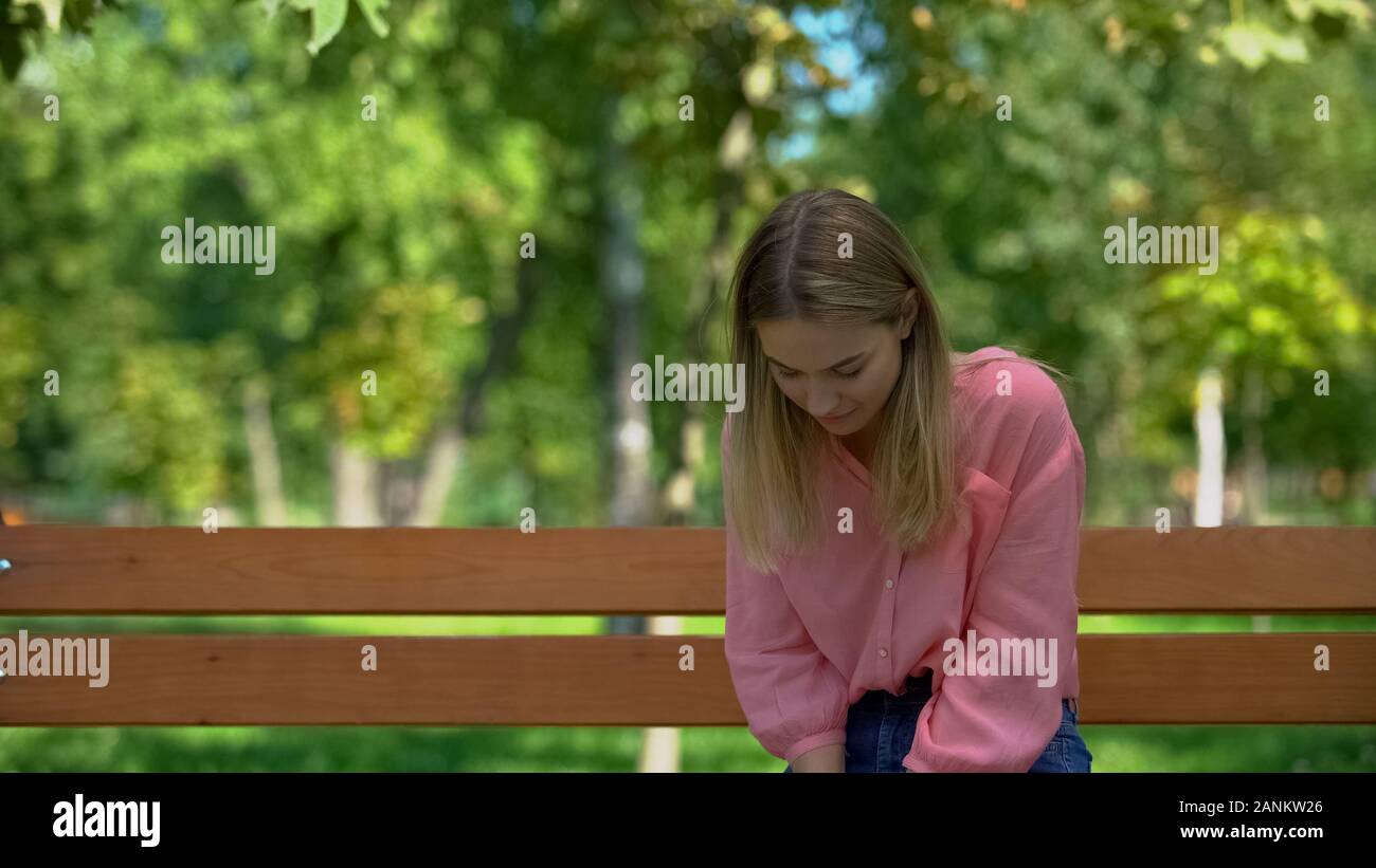 Upset caucasian woman sitting alone park bench, problem hopelessness ... Upset caucasian woman sitting alone park bench, problem hopelessness ...