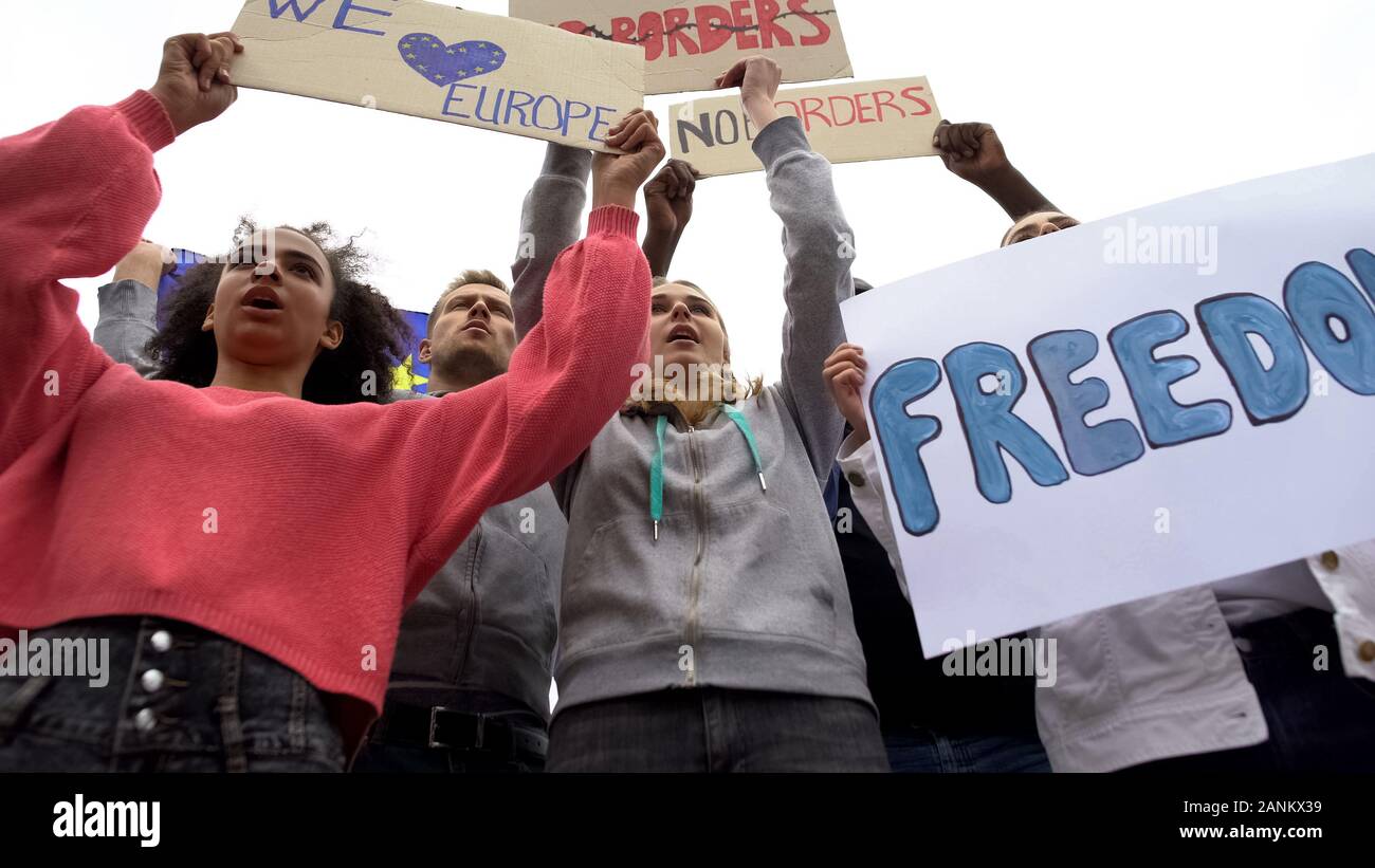 Activists chanting slogan holding posters for no borders in EU ...
