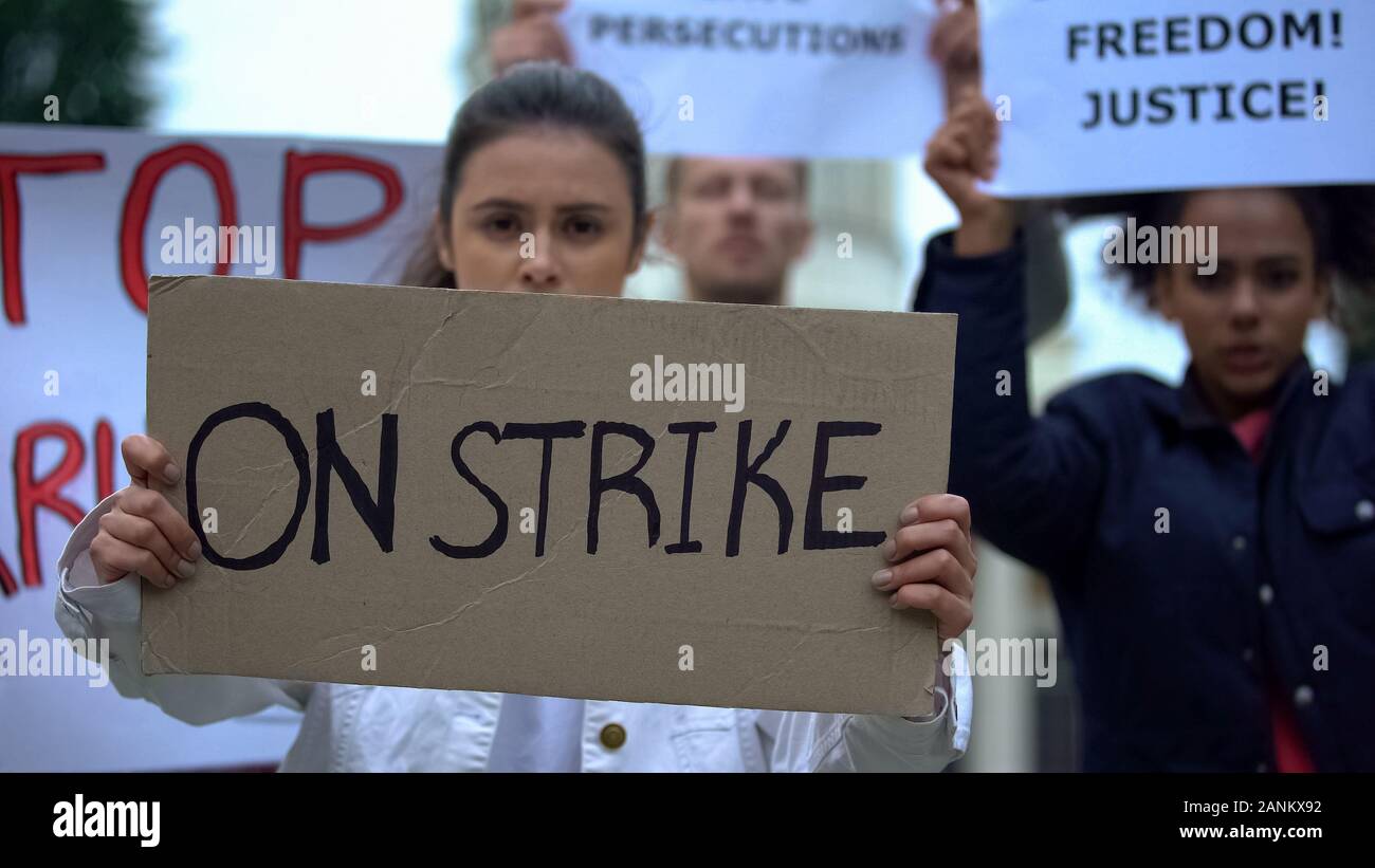 People waving banners on strike, protection of employee rights, work ...