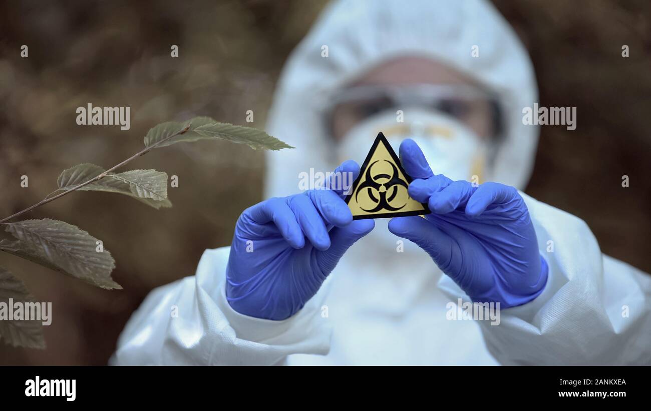 Biological hazard sign in researcher hands, health threat, virus danger ...