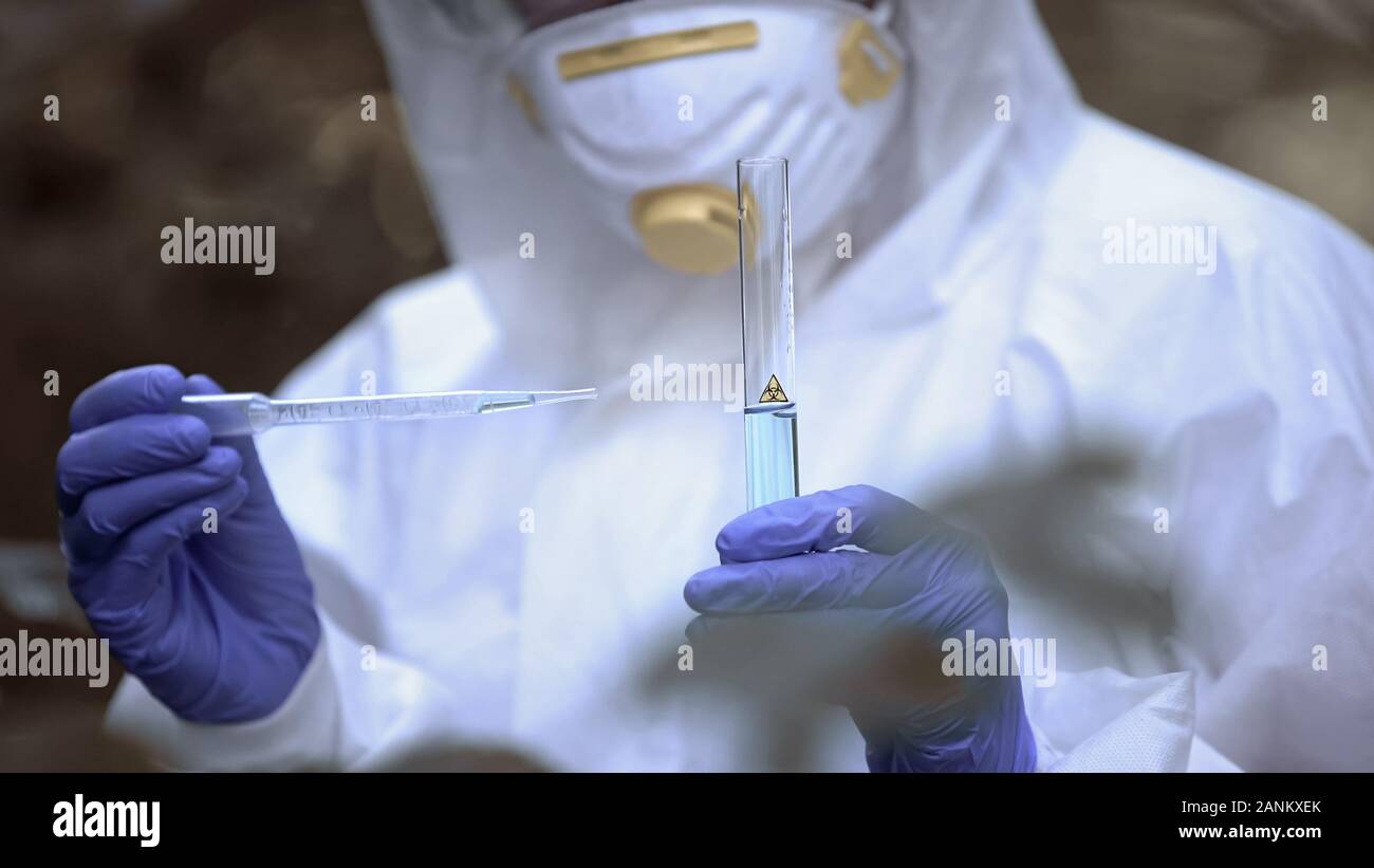 Exclusion zone researcher analyzing water sample, biological hazard ...