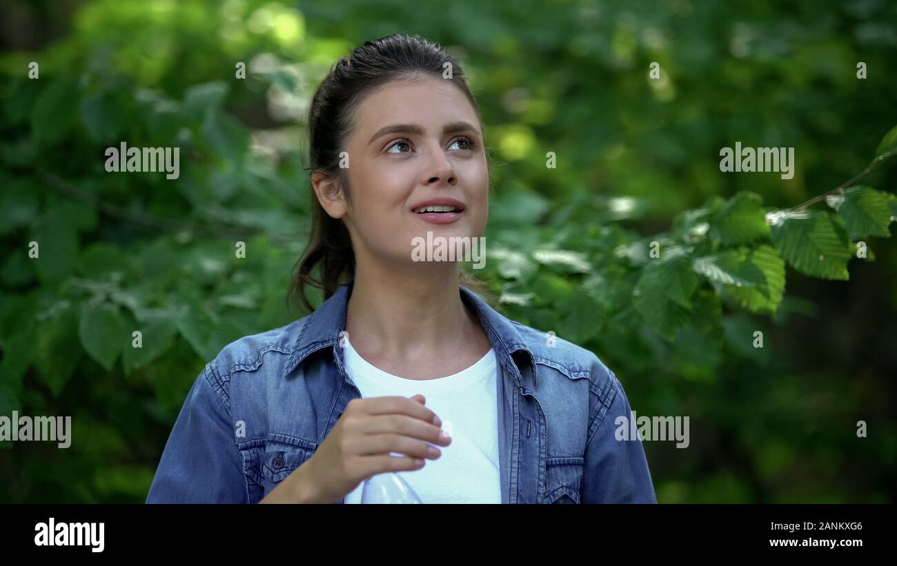 Inspired female looking around in forest, enjoying nature beauty, green ...