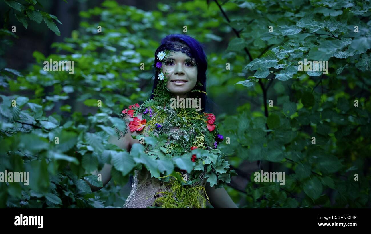 Forest nymph among trees looking camera, nature spirit, mythology ...