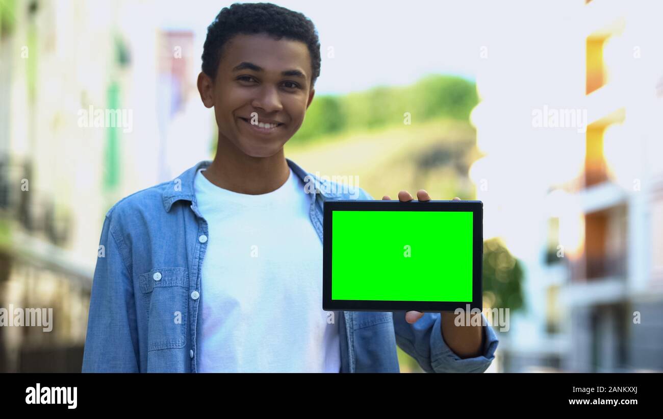 Young Afro-American boy showing green screen tablet, online education ...
