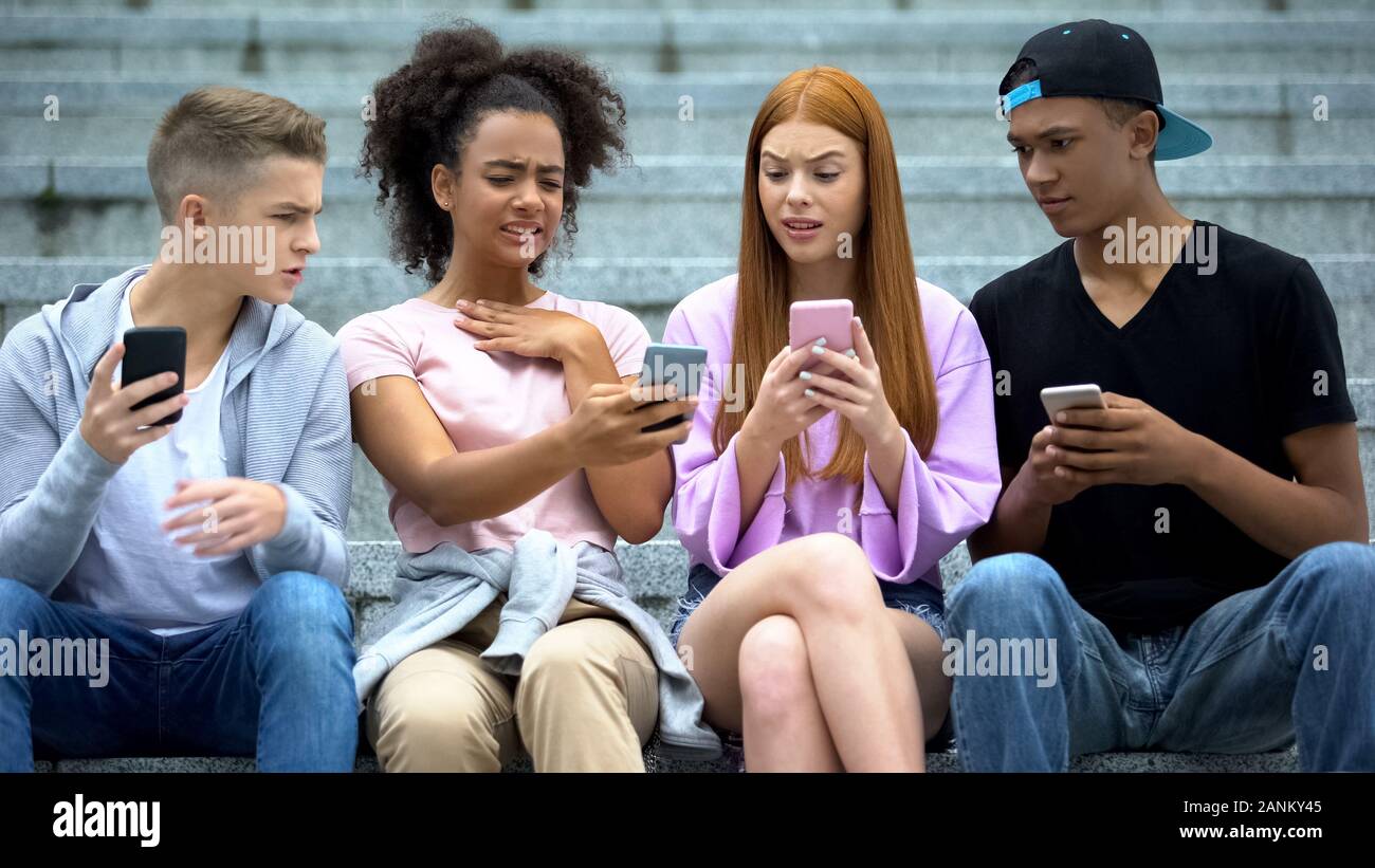 Female student showing friends disgusting video by smartphone app ...