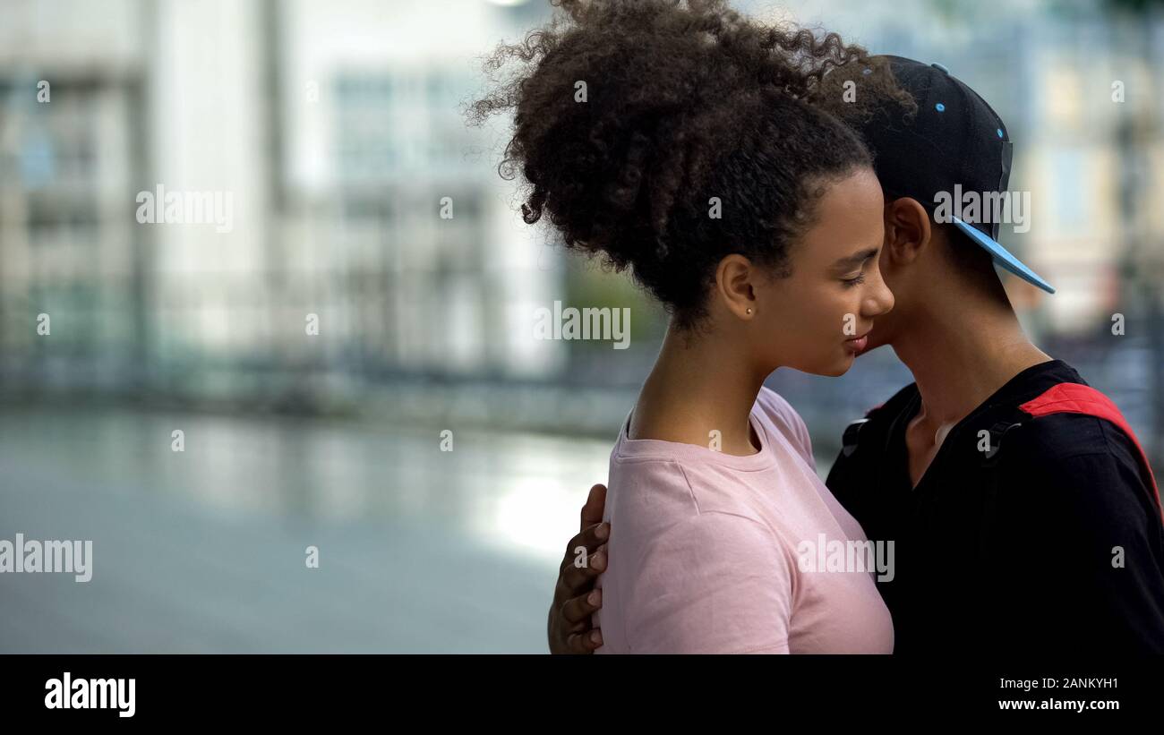 Happy african student hugging girlfriend, college pupils love romantic ...