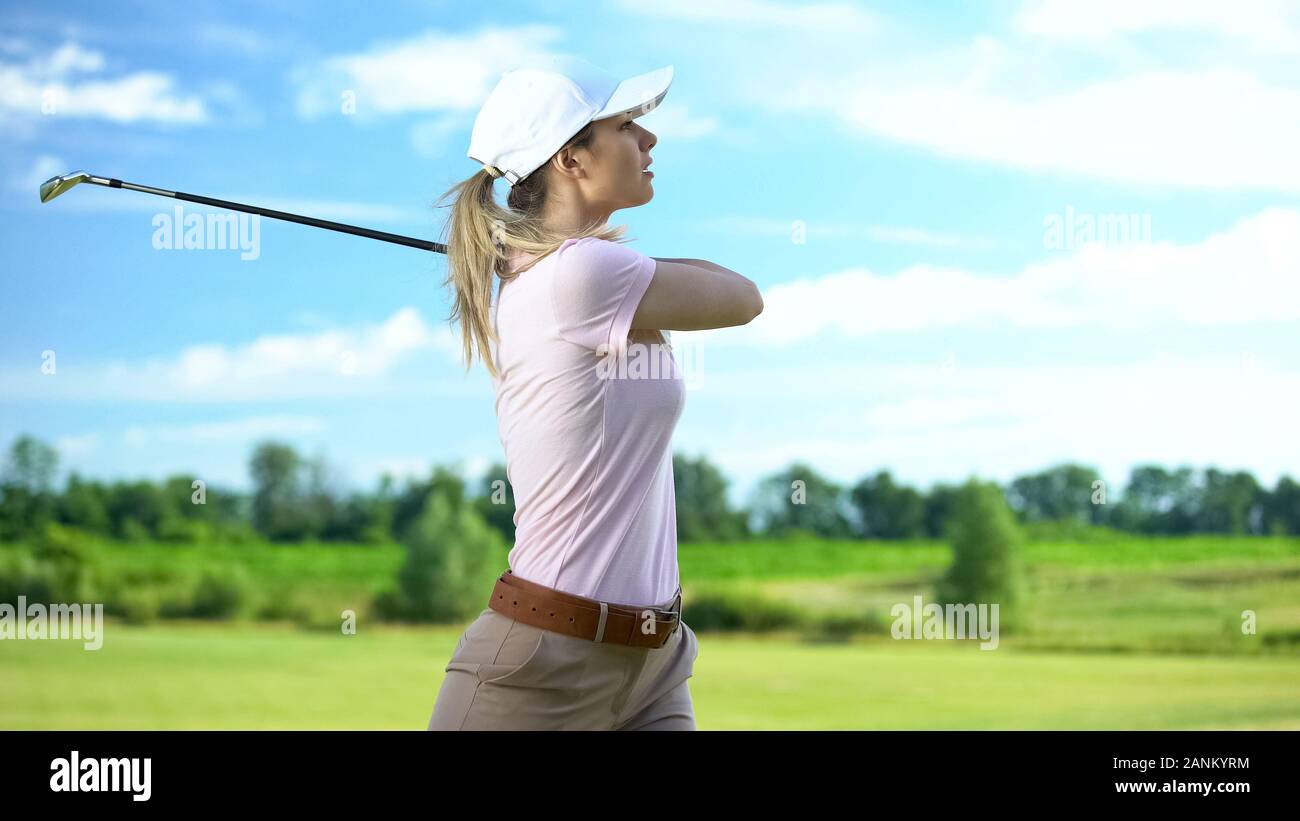 Woman playing golf in backswing position, upset about failed shot ...