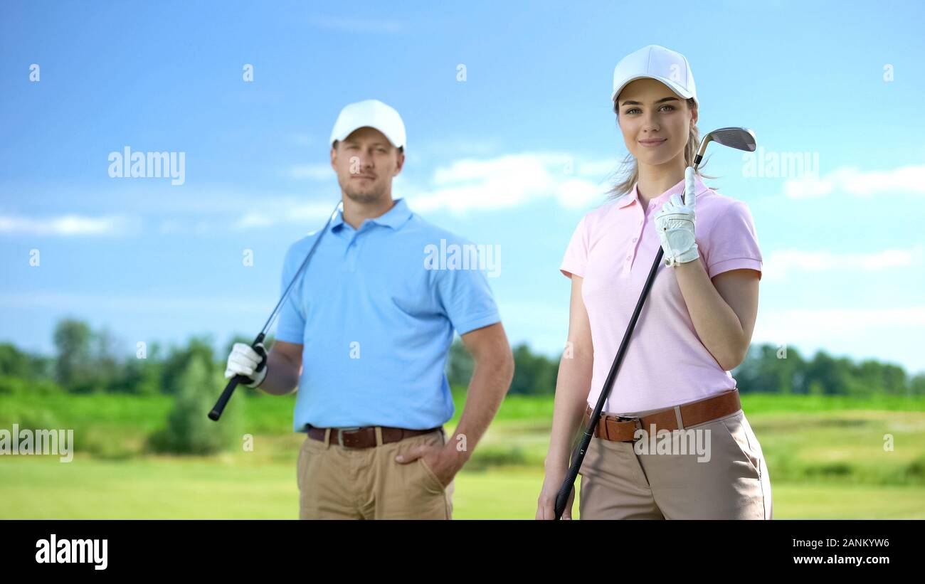 Beautiful female with golf club and sport coach smiling on camera, free ...