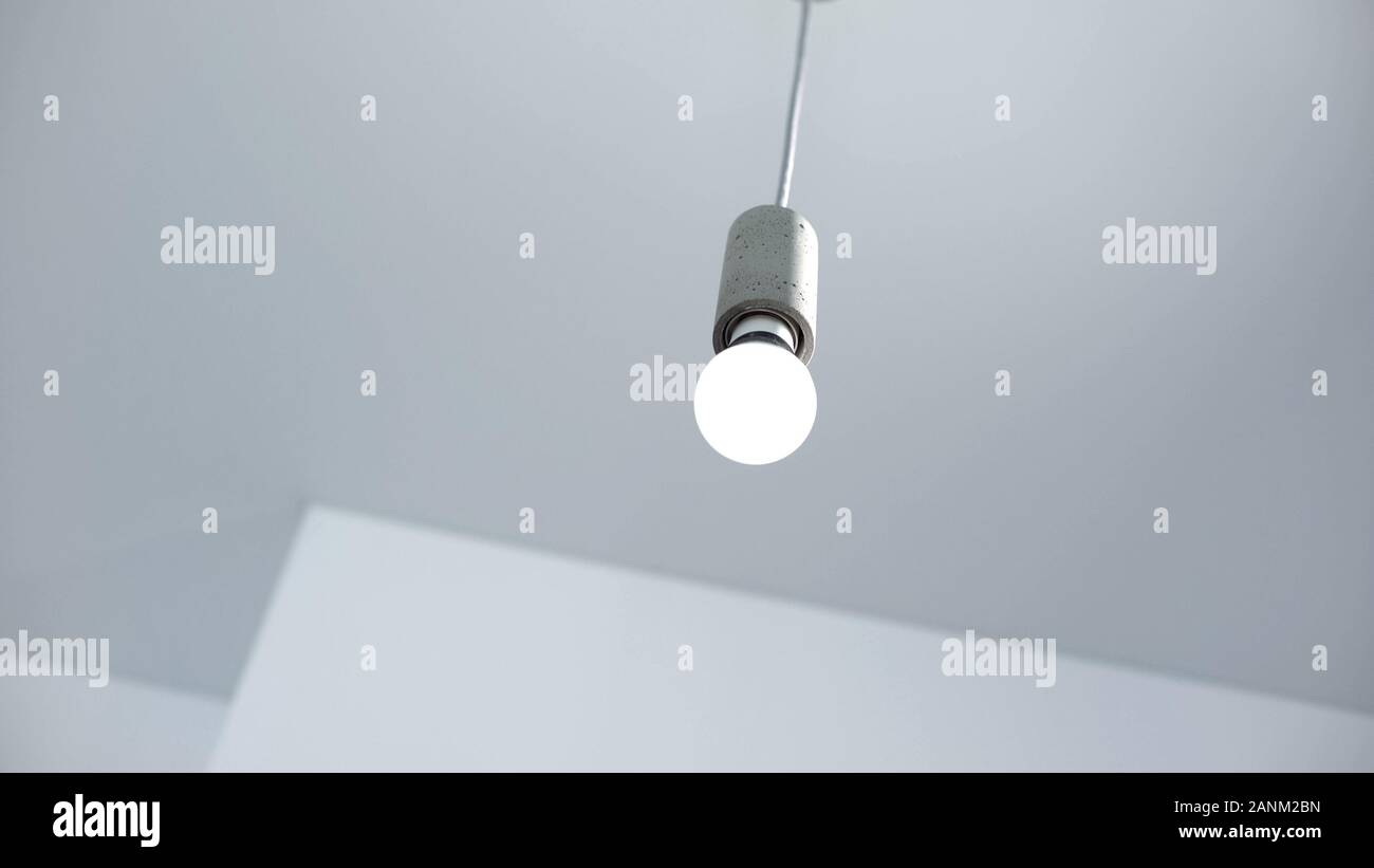 Light bulb hanging from ceiling, energy saving and energy efficiency ...