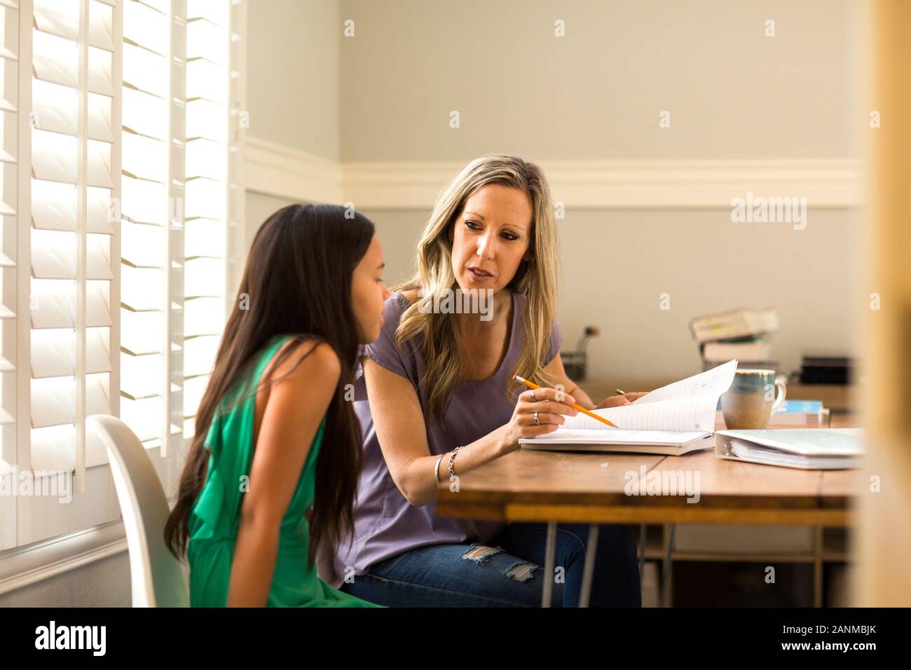 Teacher Helping Her Student With Her Homework Stock Photo - Alamy