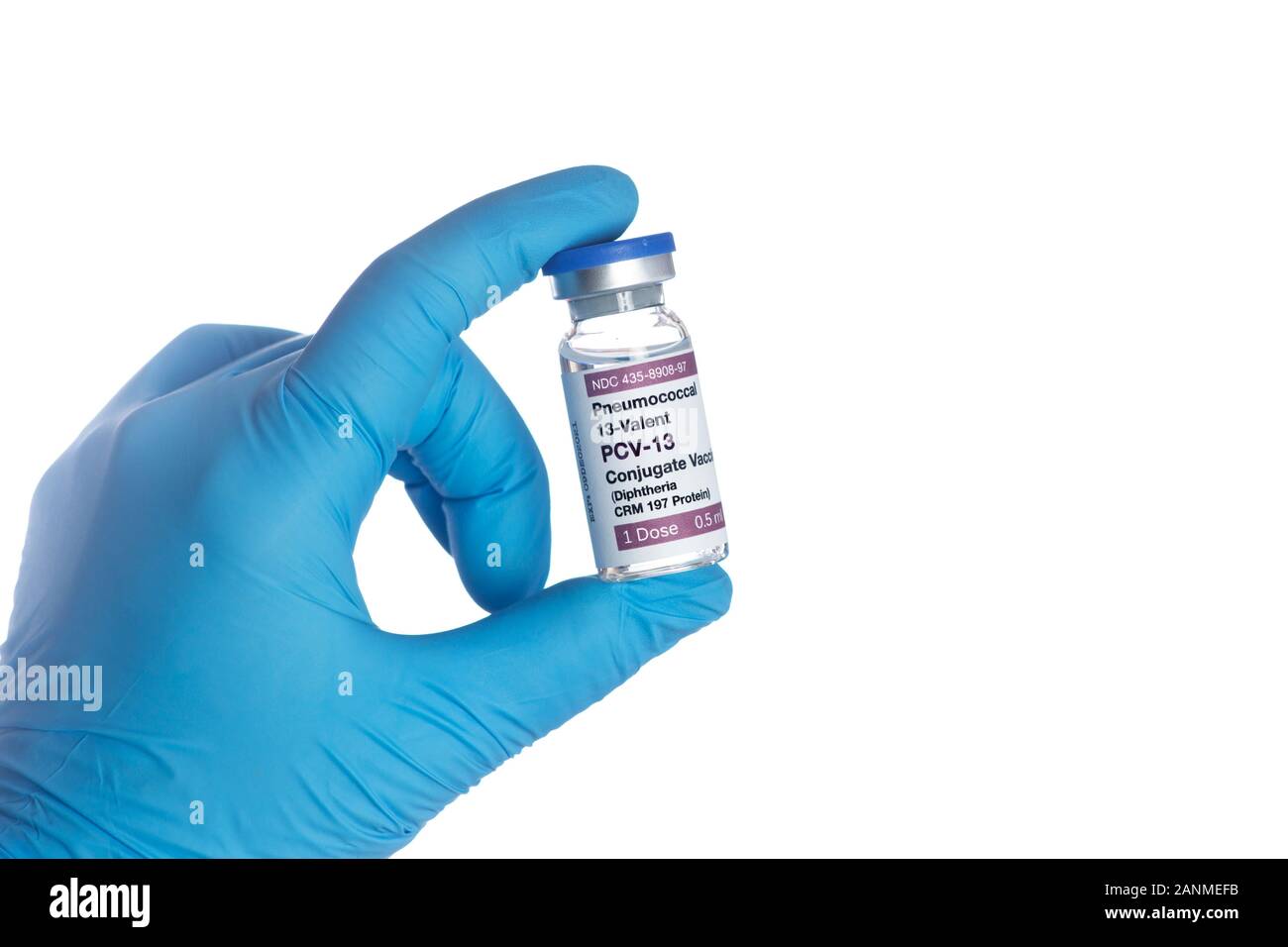 Pneumococcal 13-valent (PCV-13) vaccine vial held in gloved hand ...