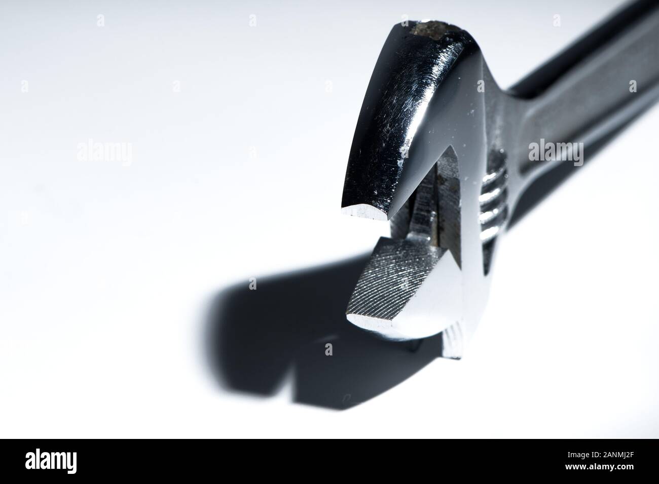 Adjustable crescent wrench with shadow on white background. Abstract ...