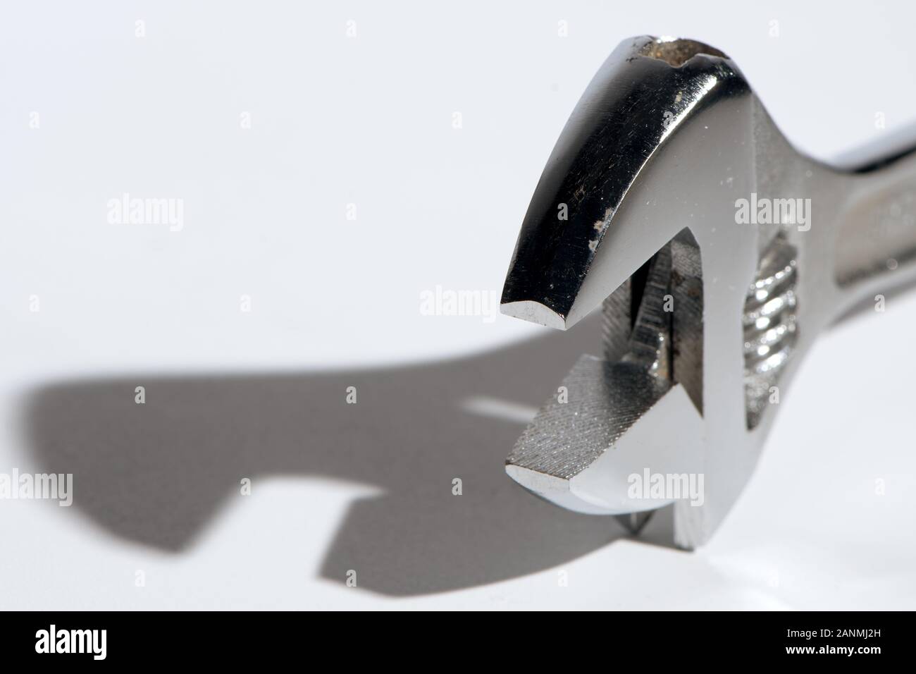 Adjustable crescent wrench with shadow on white background. Abstract ...