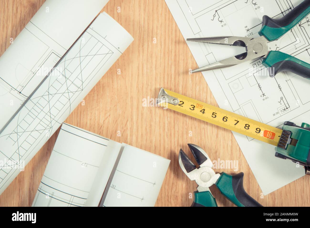 Rolls of diagrams or electrical construction drawings and work tools ...