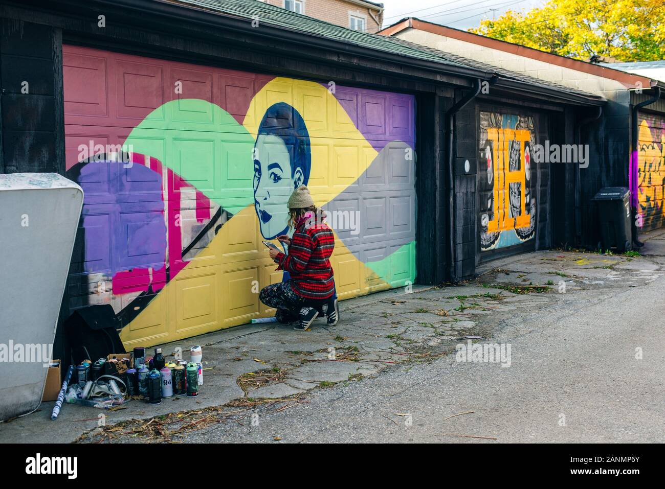canada, toronto - december, 2019 Graffiti artist spraying the wall ...