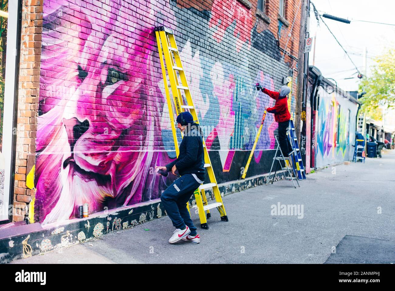 canada, toronto - december, 2019 Graffiti artist spraying the wall ...