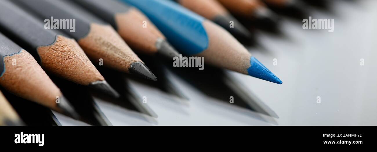 Blue pencil spy between black pencils Stock Photo - Alamy
