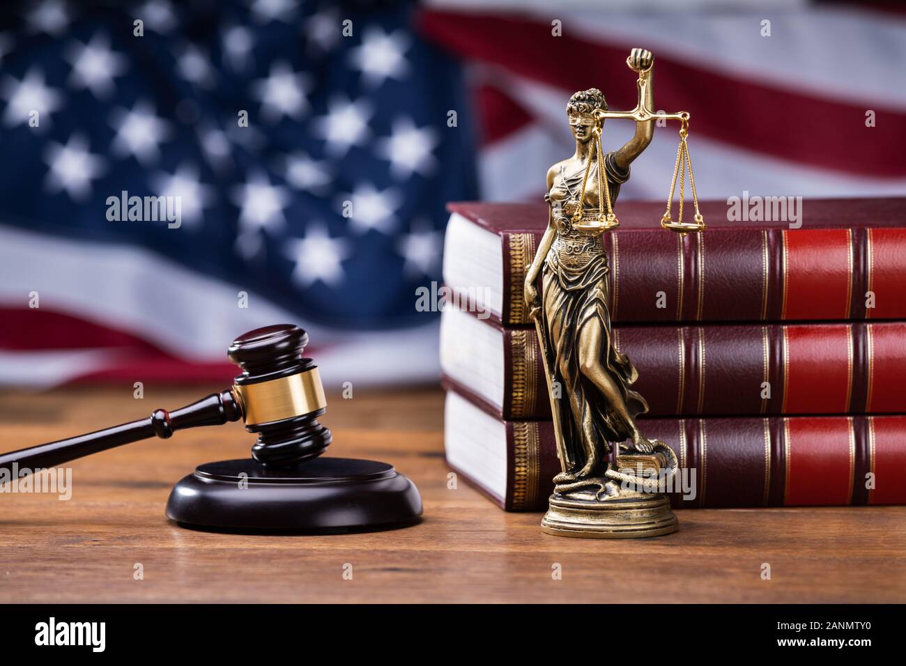 Wooden Gavel With Golden Scales On Table In Front Of US Flag Stock ...