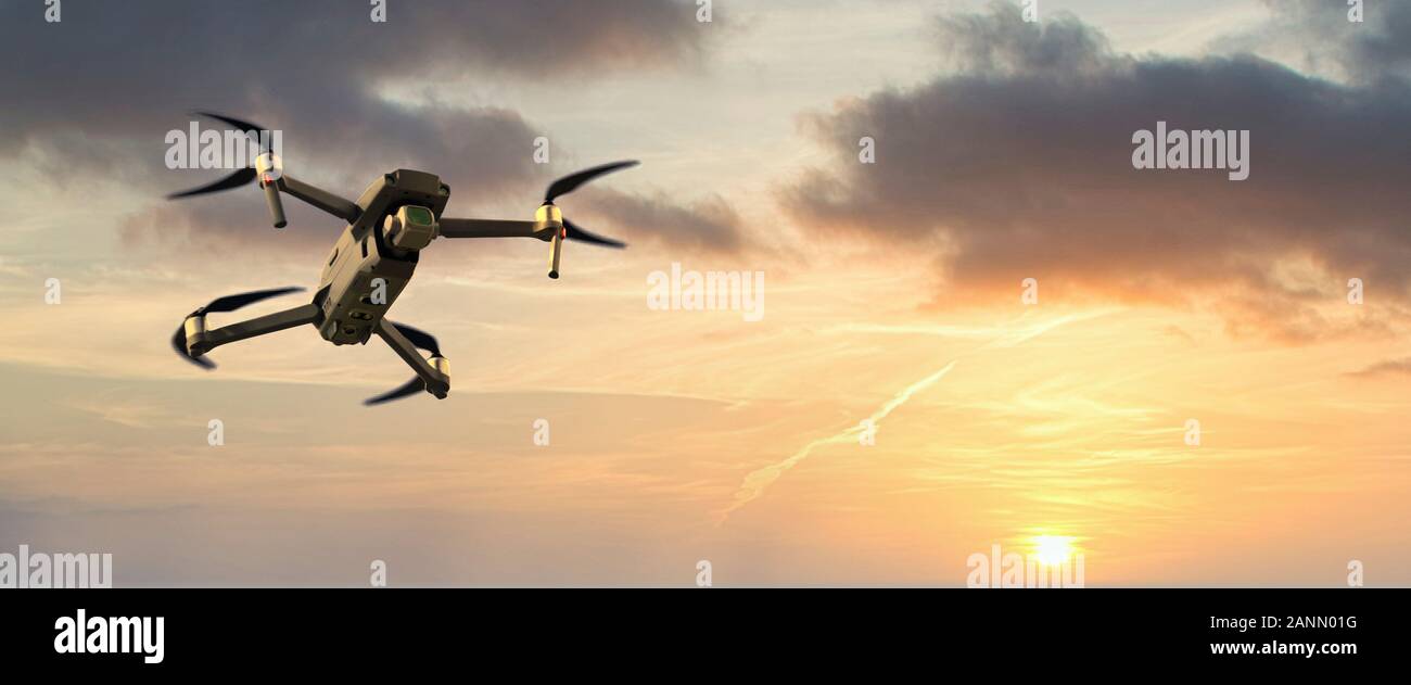 Drone flying in night sky during sunset Stock Photo - Alamy