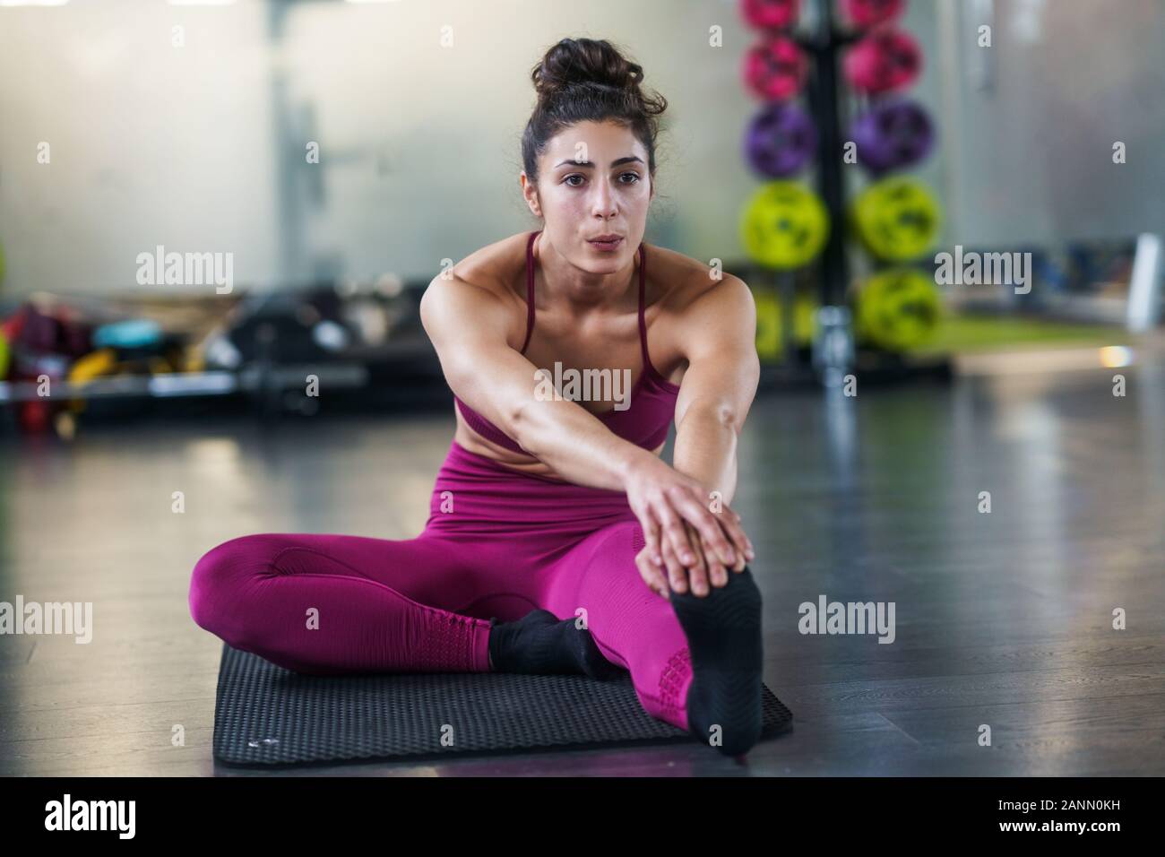 Young woman Doing Stretching Exercises on a yoga mat Stock Photo - Alamy