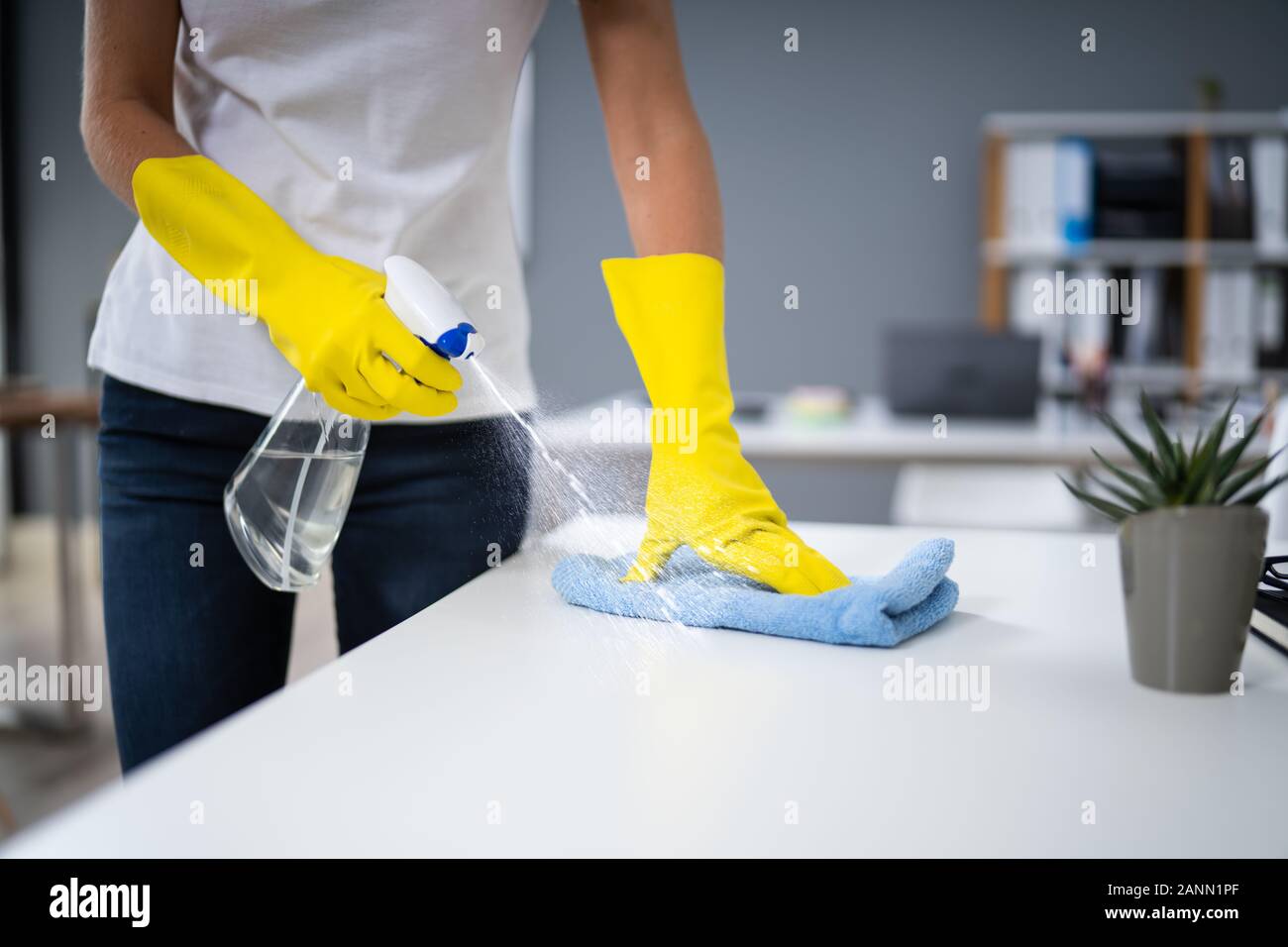 Young Worker Cleaning Desk With Rag In Office Stock Photo - Alamy