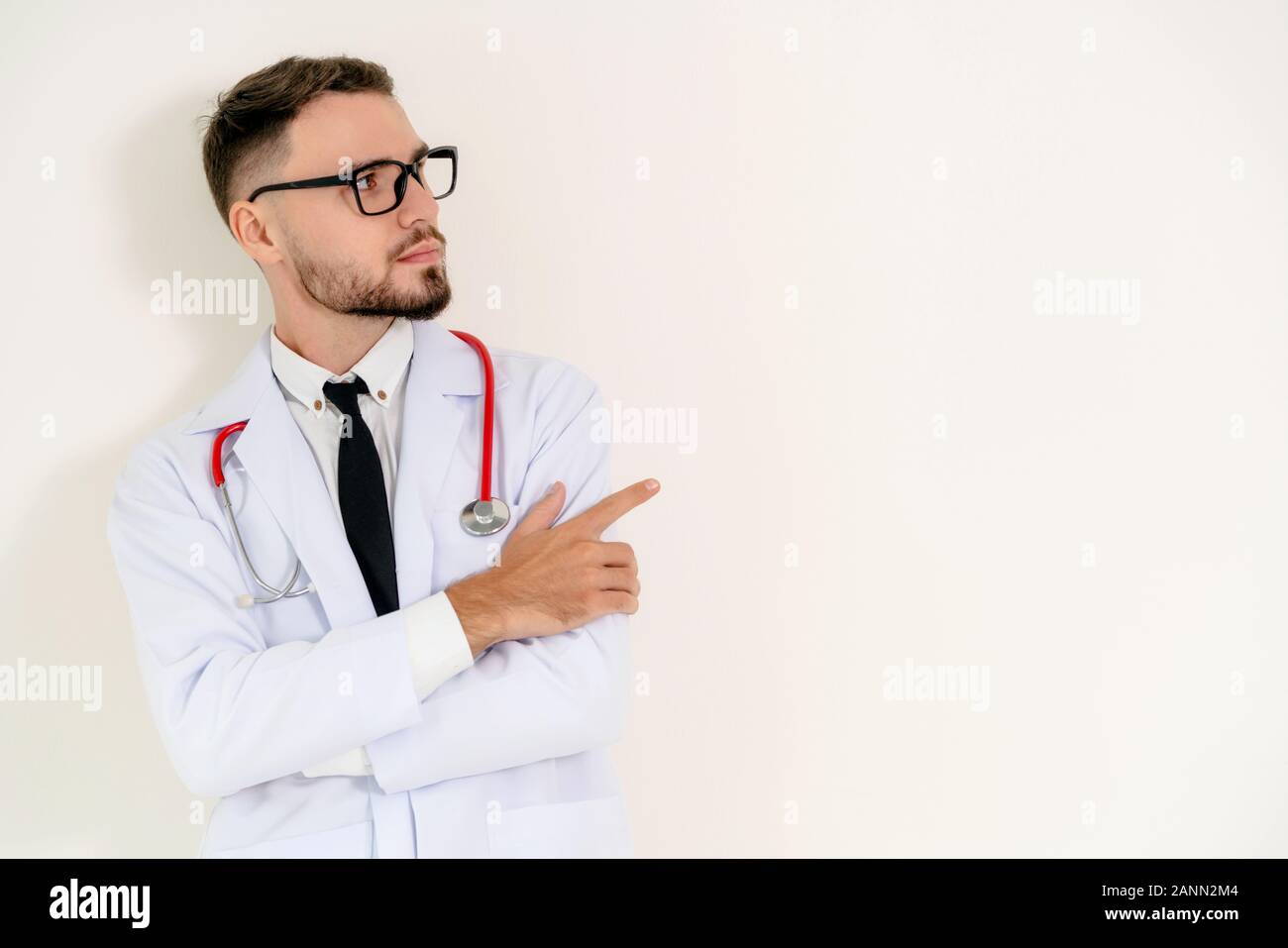 Male doctor pointing finger at blank space on white background. Medical ...