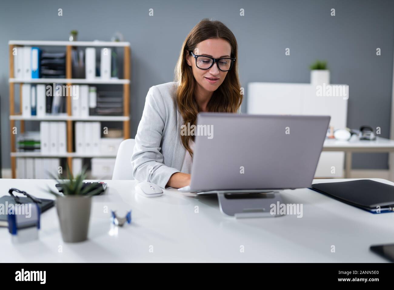 Boss sitting behind desk hi-res stock photography and images - Alamy