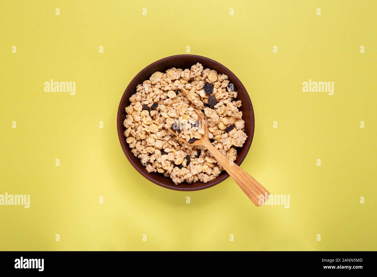dry granola with nuts and dried fruits in a plate on the table. place ...