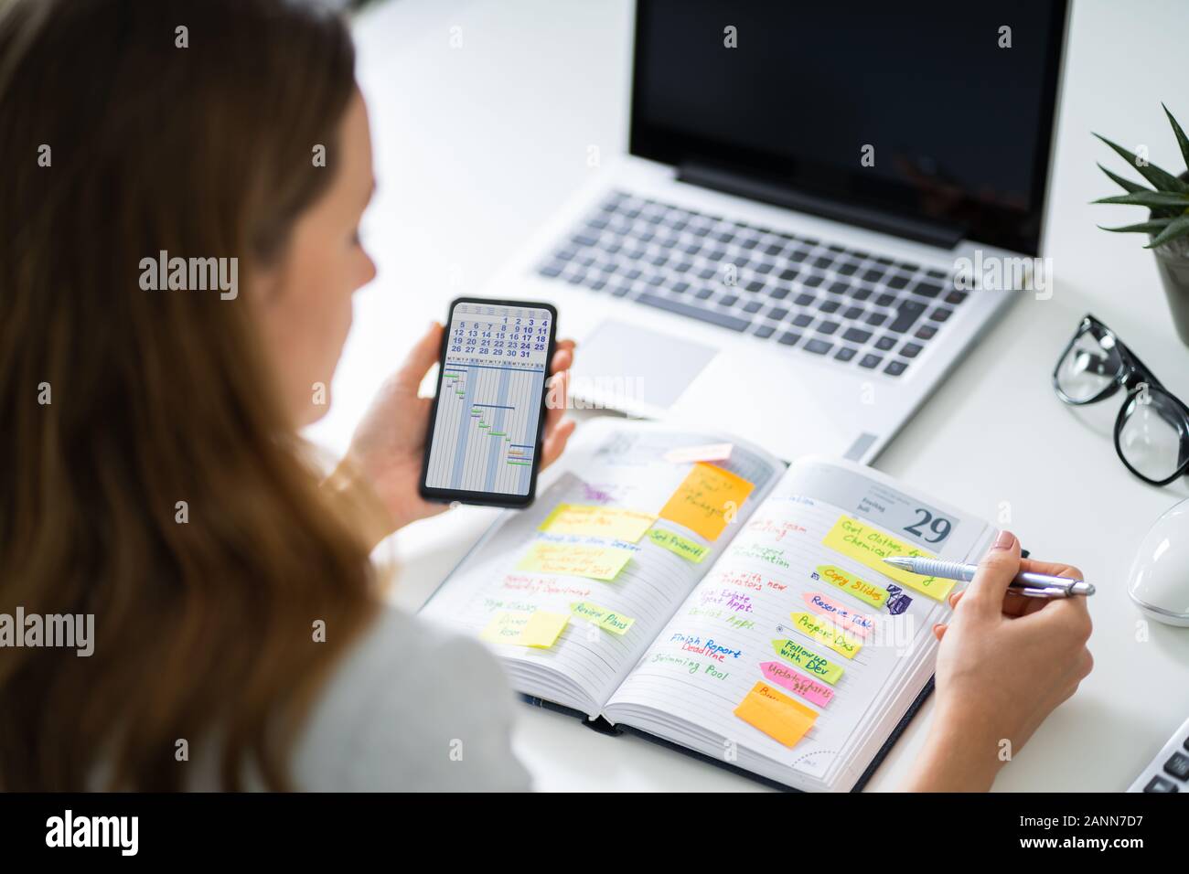 Person Hands With Mobile Phone And Diary Stock Photo - Alamy