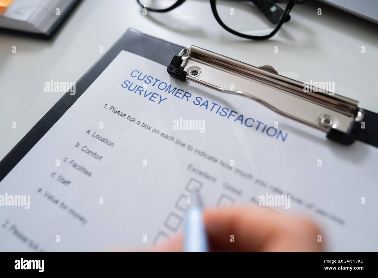 Close-up Of Woman's Hand Filling Customer Survey Form Stock Photo - Alamy