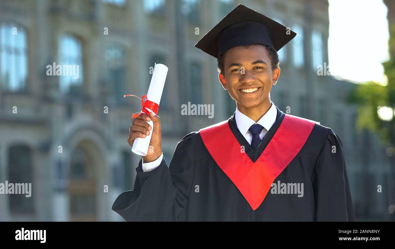 Joyful college student showing diploma celebrating graduation day ...
