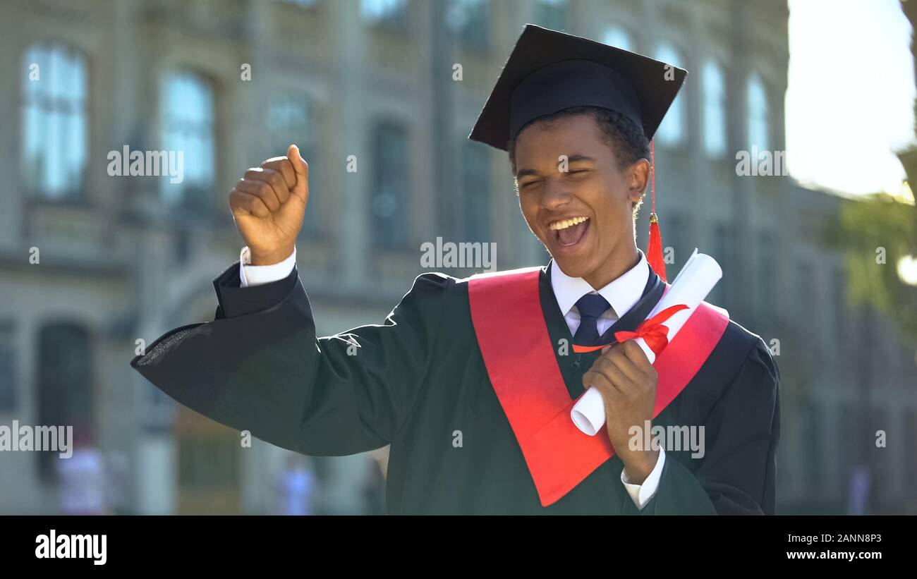 Happy student celebrating graduation dancing hi-res stock photography ...