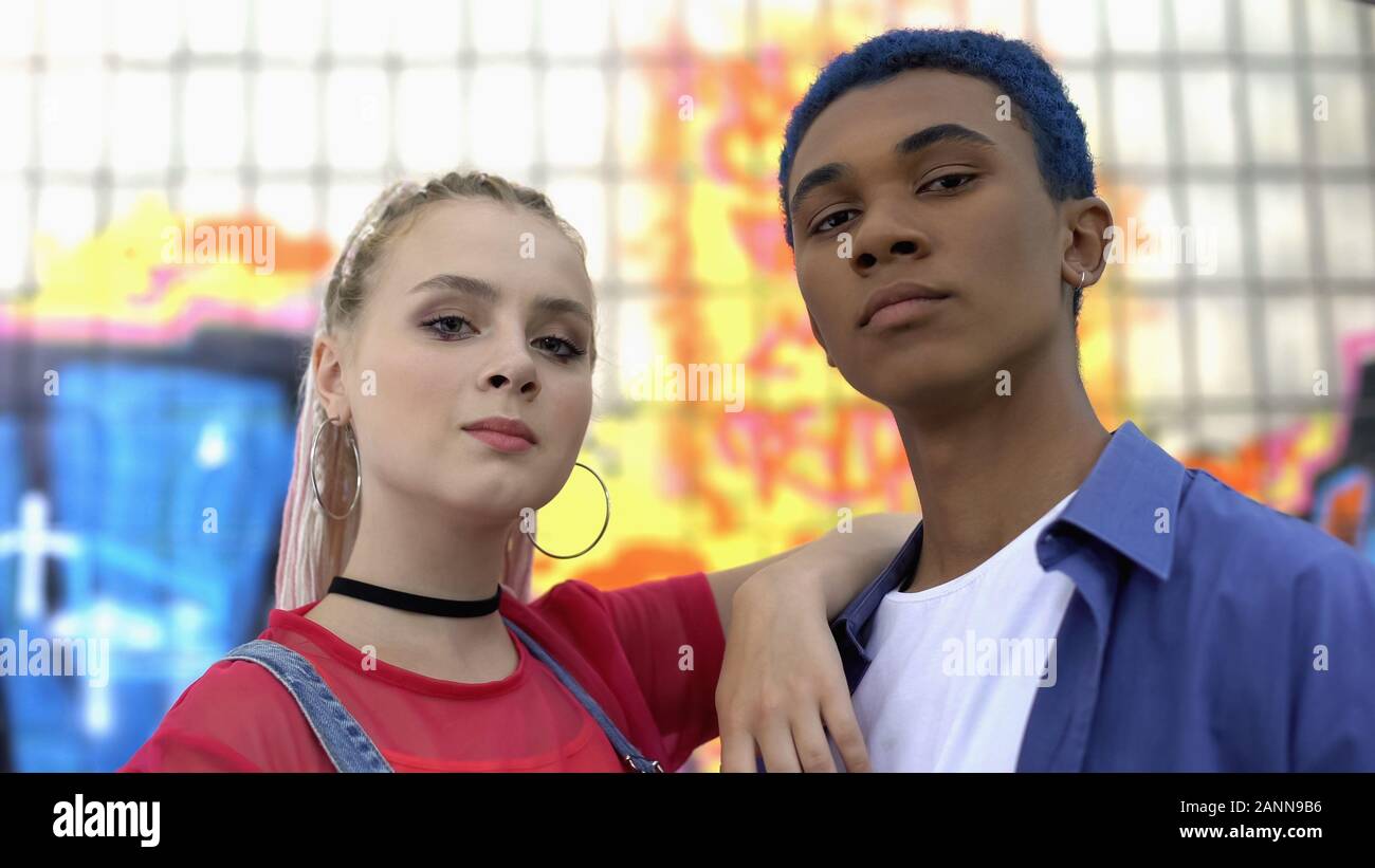 Stylish male and female teenagers looking camera, urban youth trends ...