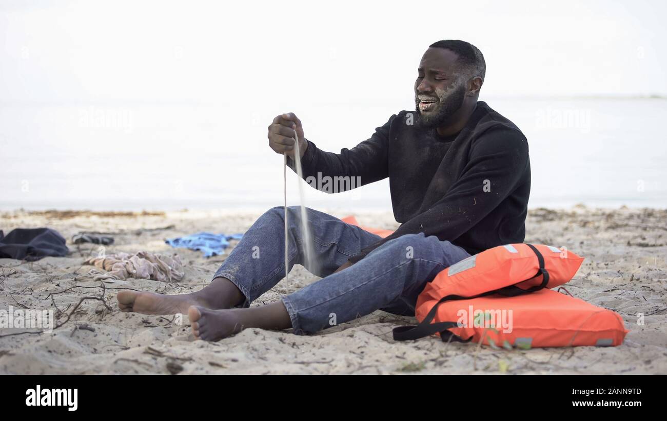 Desperate black man crying on shore, refugee survived shipwreck, lost ...