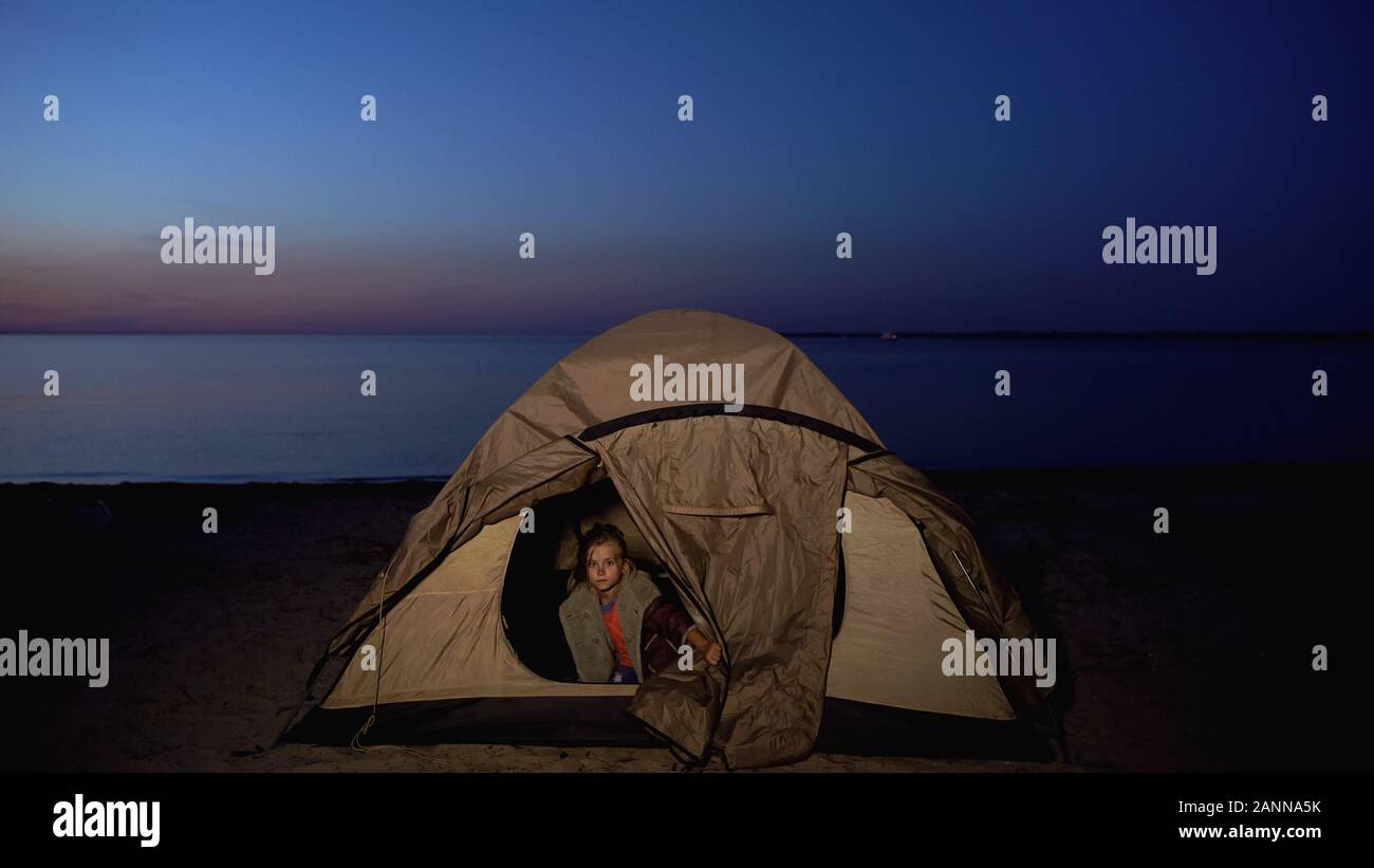 Child hiding in tent, coast guard lighting with flashlight, homeless ...