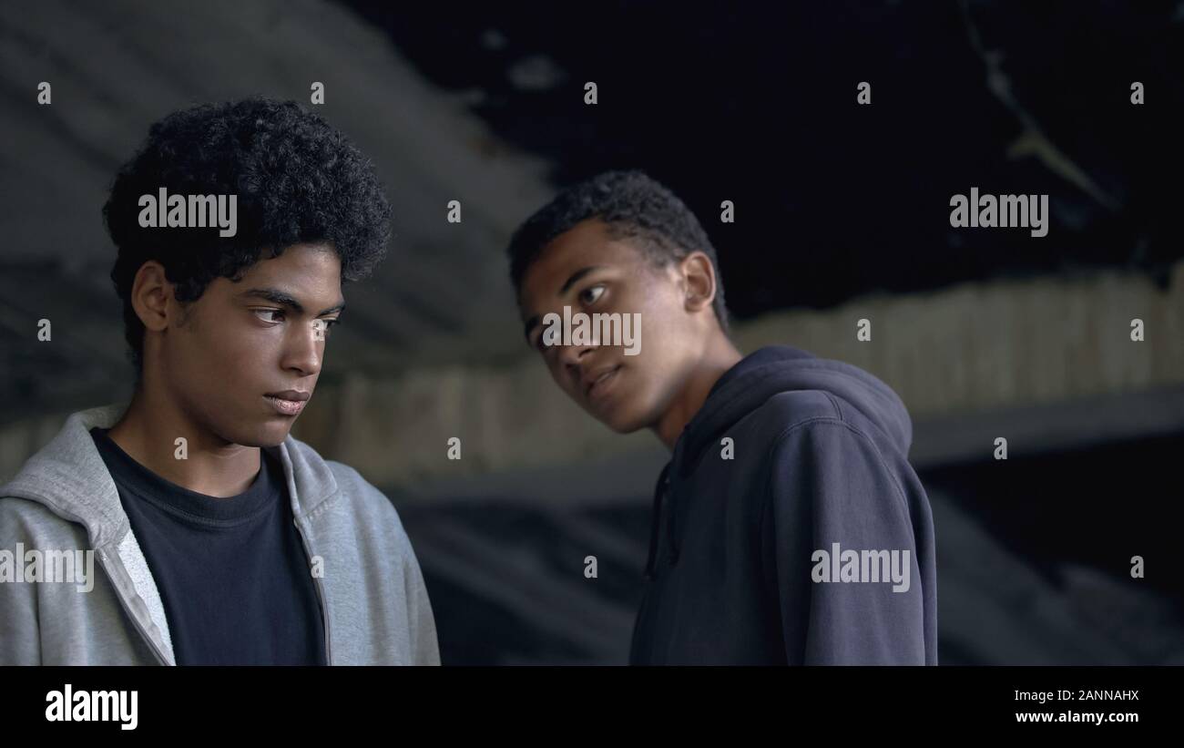 Afro-american bully threatening boy in abandoned house, bullying ...