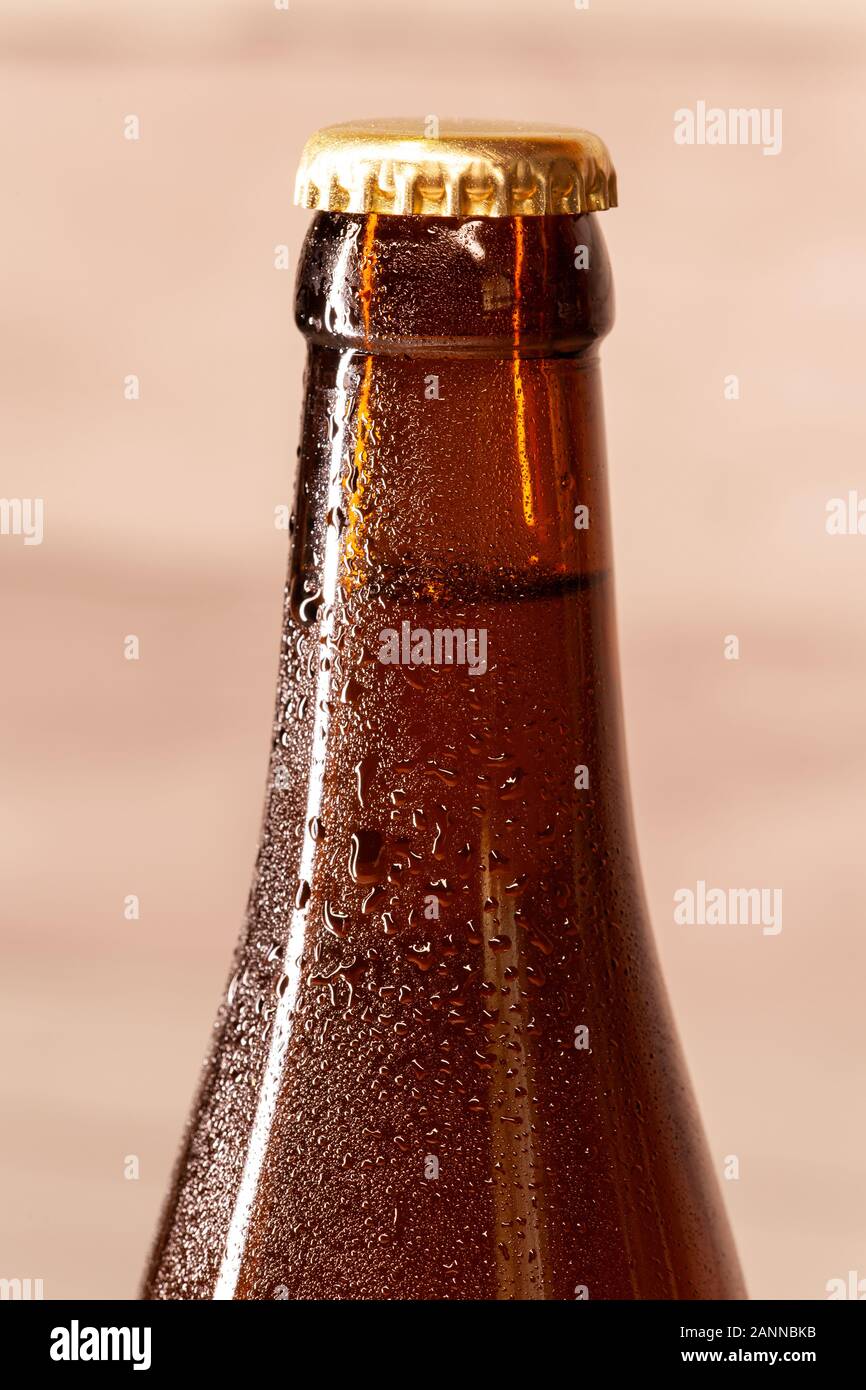 a bottle of amber beer with its capsule Stock Photo - Alamy