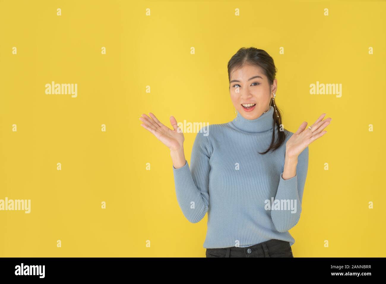Woman spreading fingers with face in the yellow background Stock Photo ...