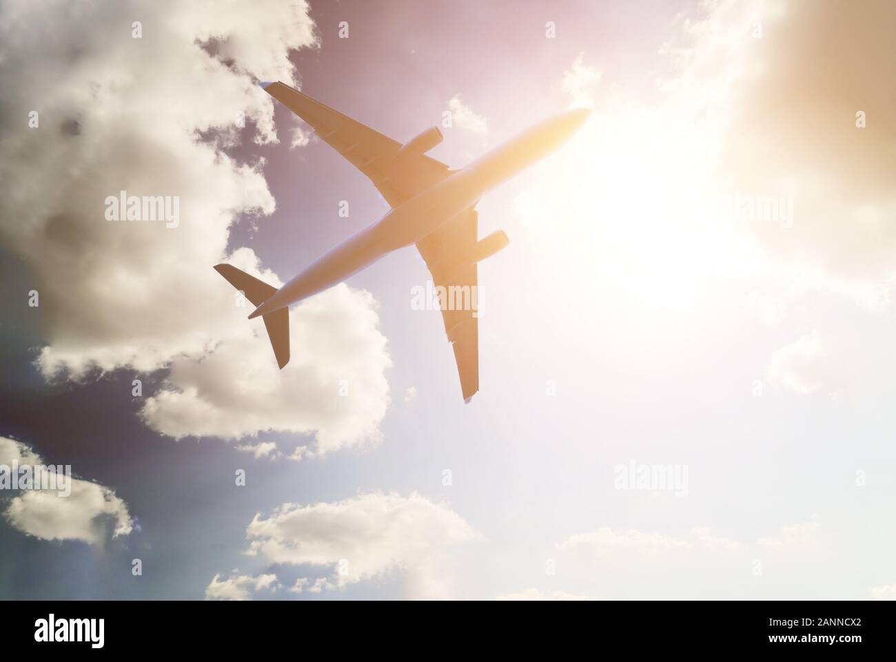 Bottom view of flying airplane in sky among clouds in afternoon Stock ...