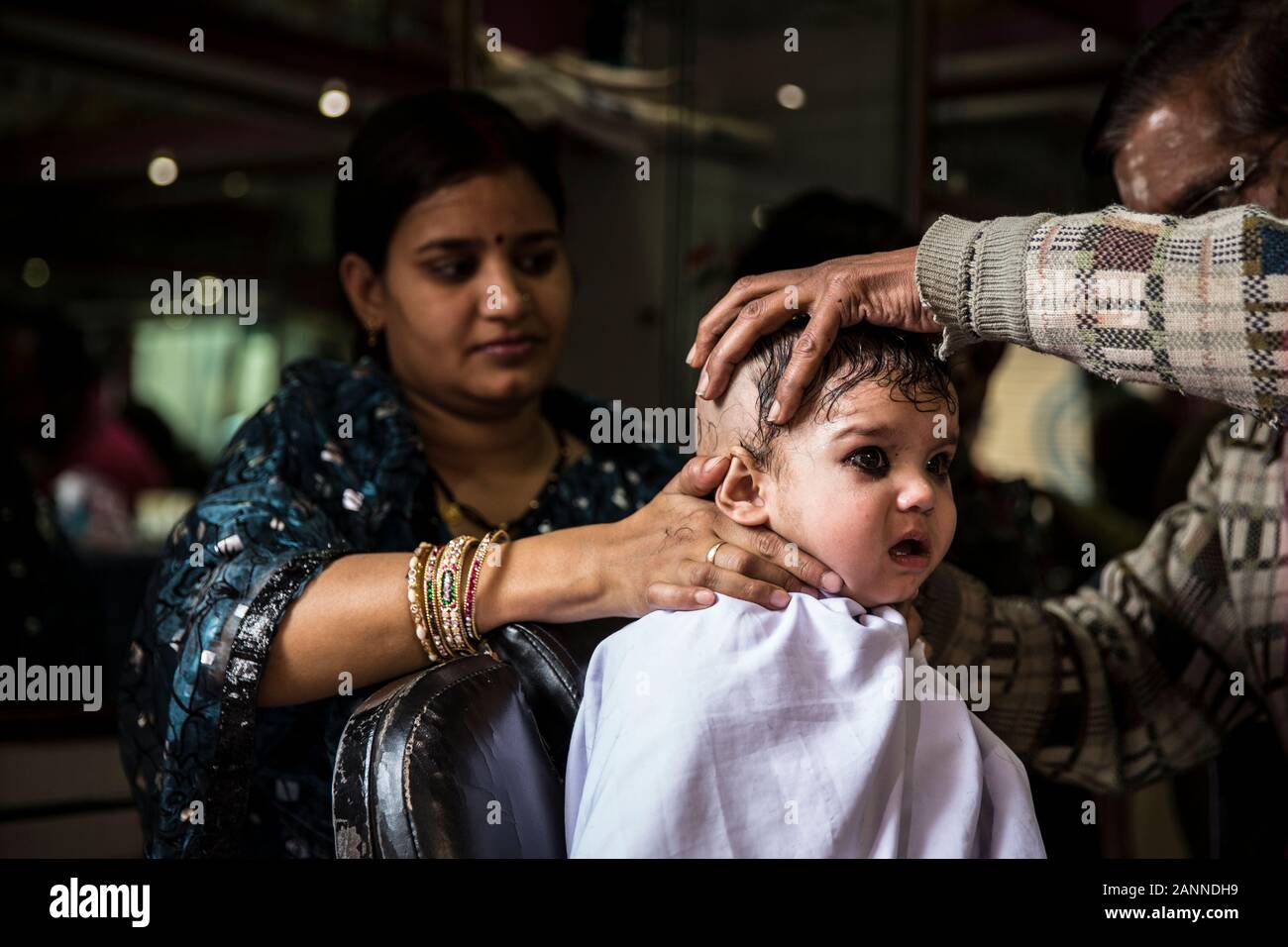 Kid crying having his first haircut. Varanasi, India Stock Photo - Alamy
