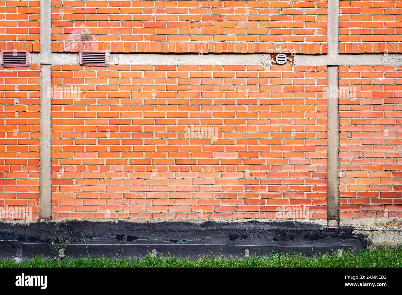 Red lined brick wall background with green grass Stock Photo - Alamy