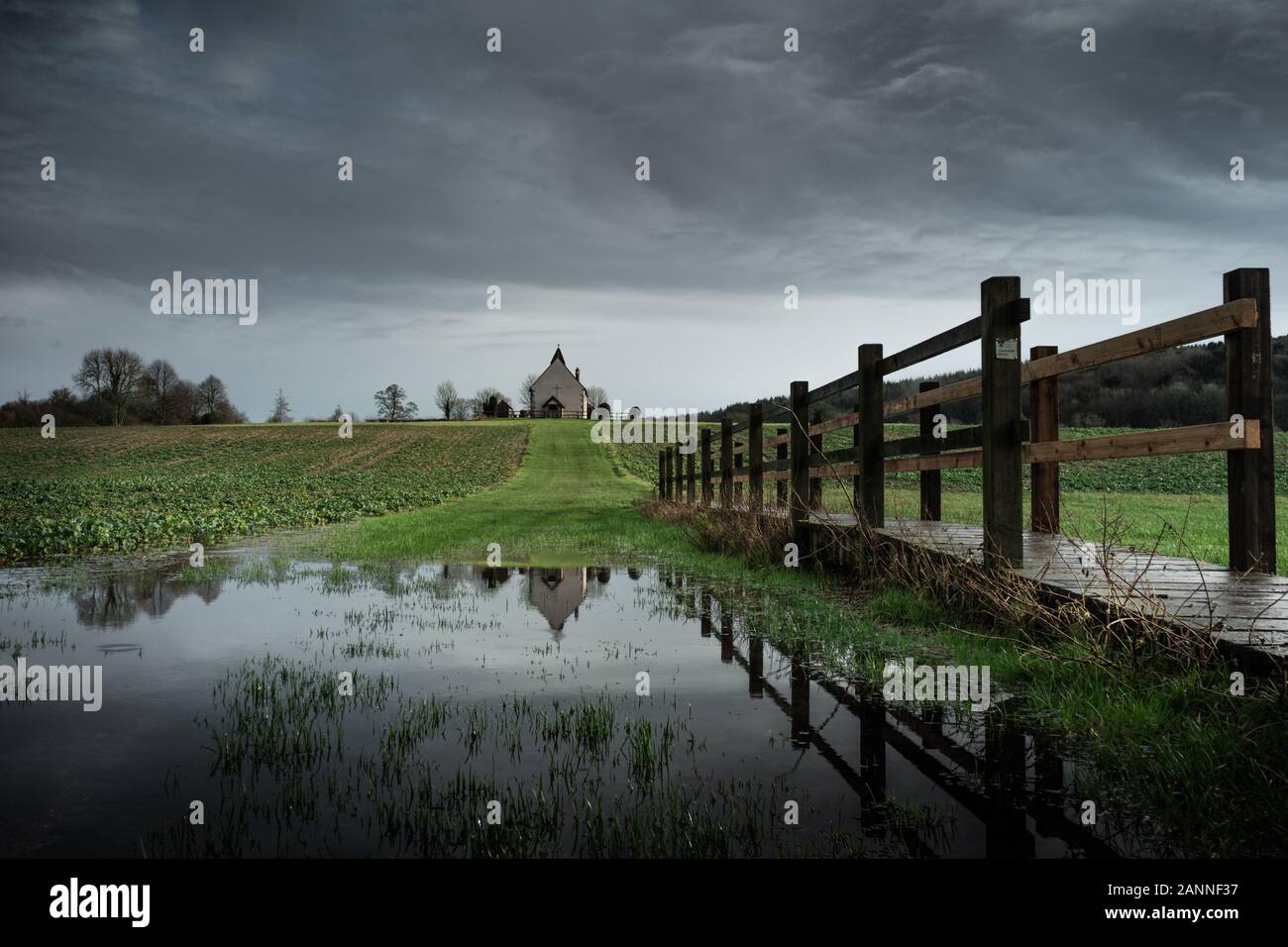 St Huberts Chapel in Idsworth Hampshire reflecting in water after rain ...