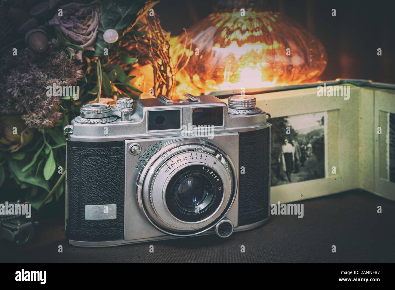 Vintage camera, album with old photos an decoration on table. nostalgic ...