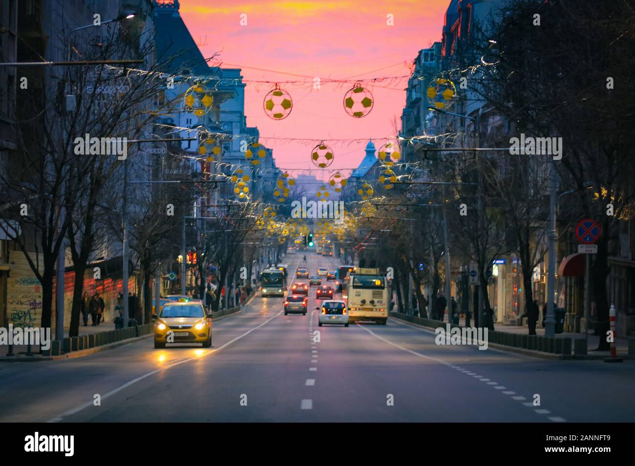 Sunset and evening traffic on the main boulevard in downtown Bucharest ...
