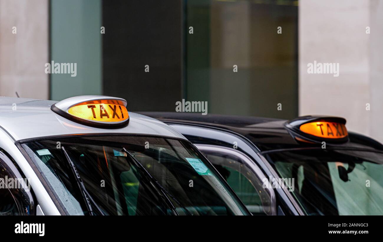A british london black taxi cab sign with defocused background - image ...