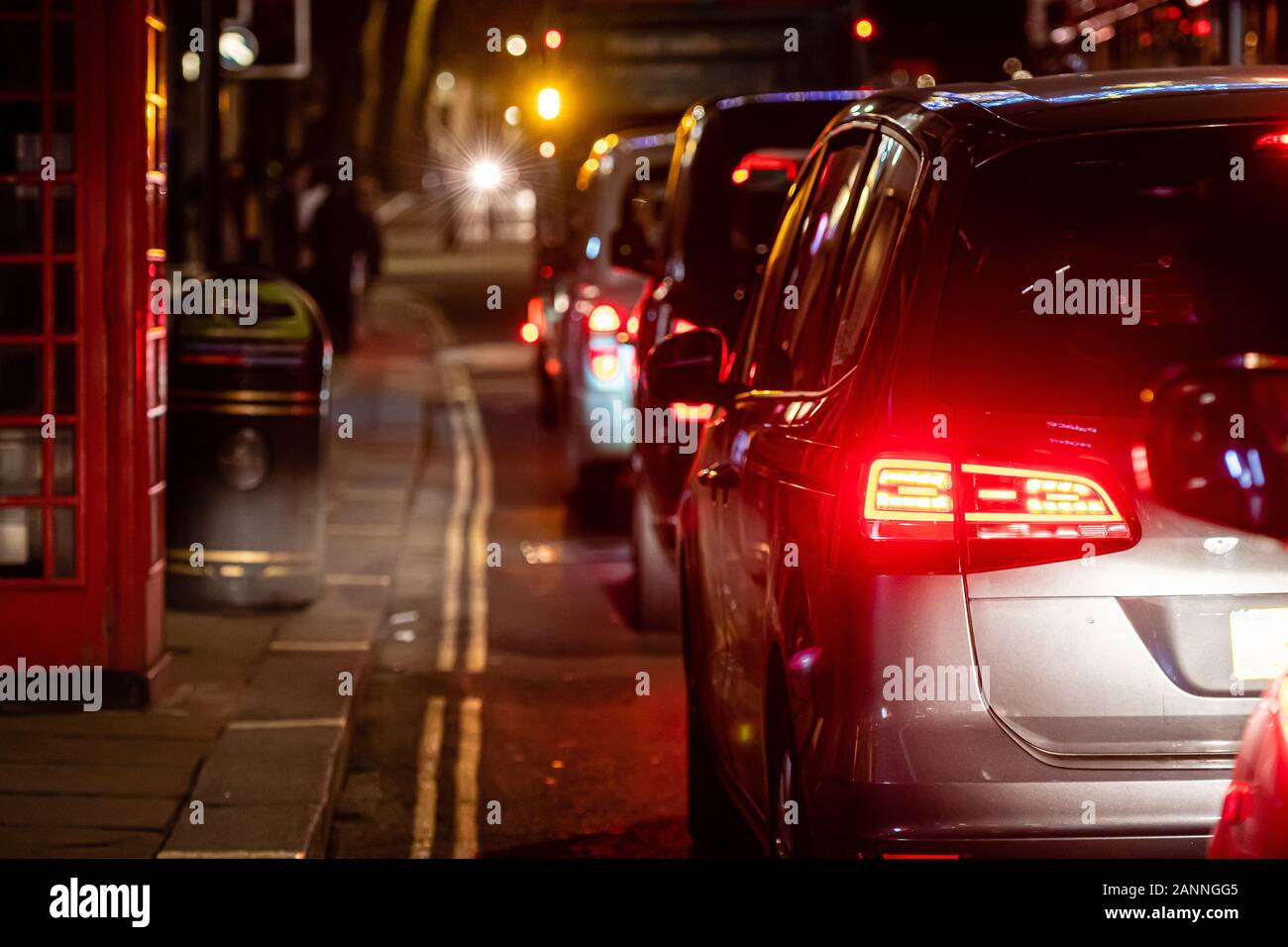 The rear view on the traffic jam on the downtown street at night ...